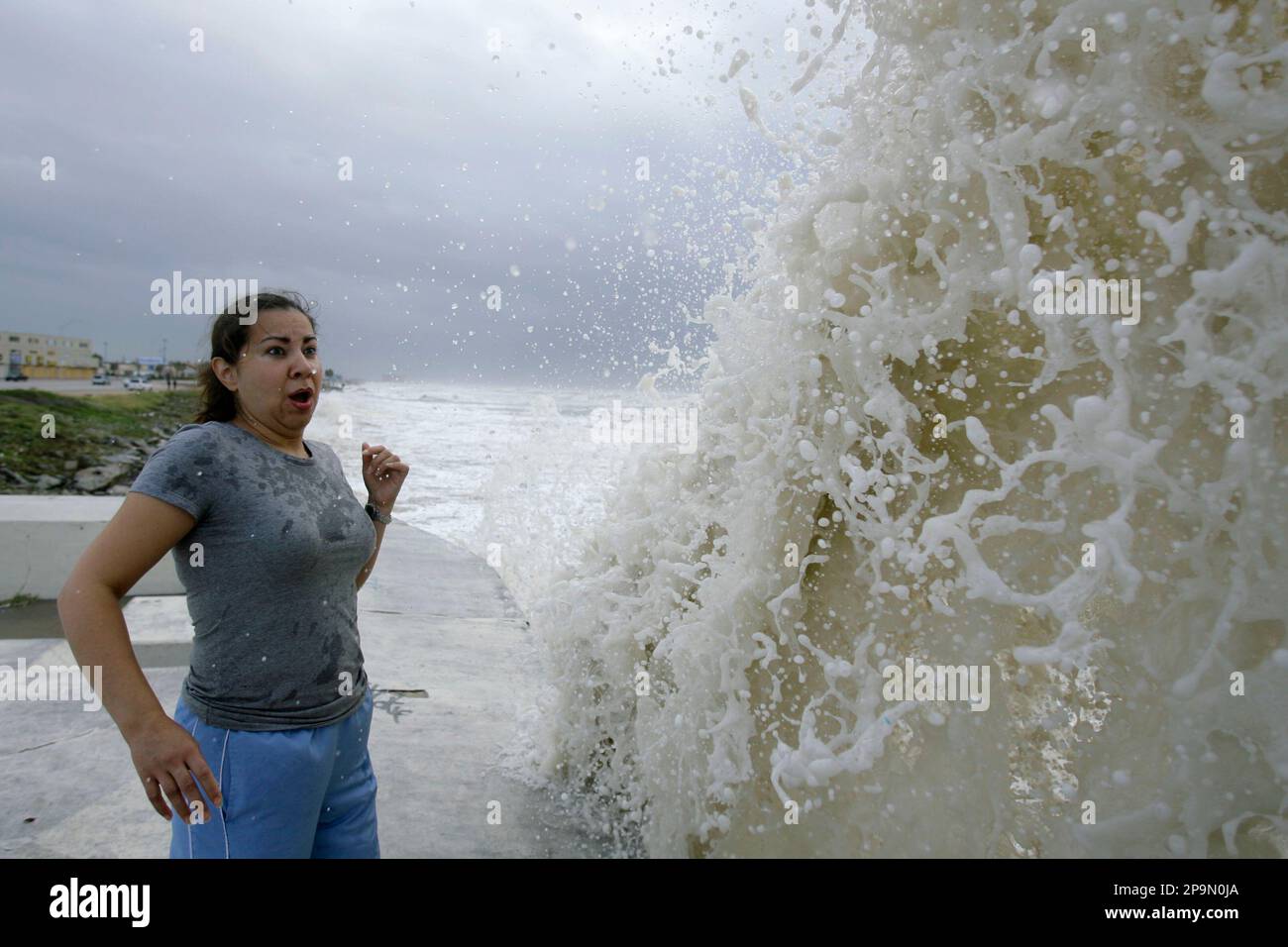 Sylvia Renteria, of Houston, watches a big wave caused by approaching ...