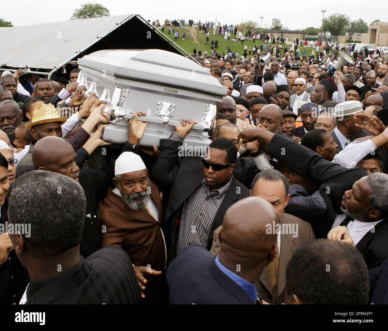 Family members carry the body of Imam W. D. Mohammed, son of Nation of ...
