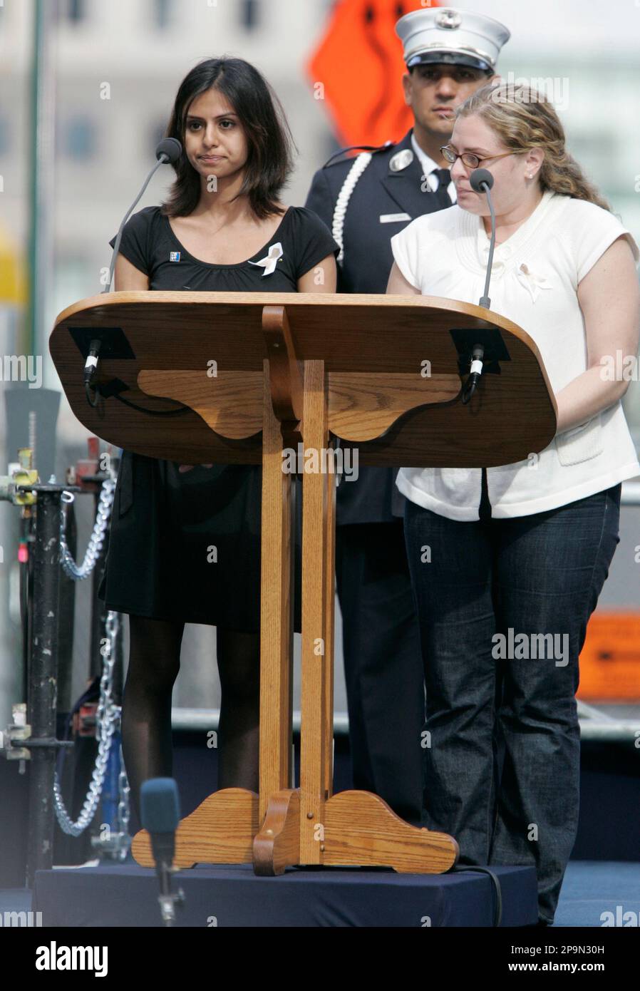 Poora Ronadive, of India, left, reads the names of the victims of the ...