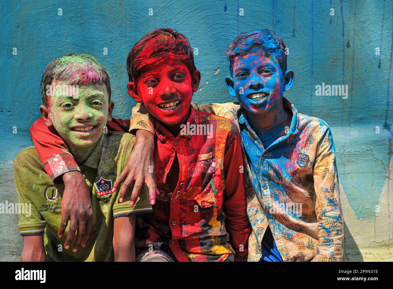 Children at a tea garden with painted faces in rainbow colours ...