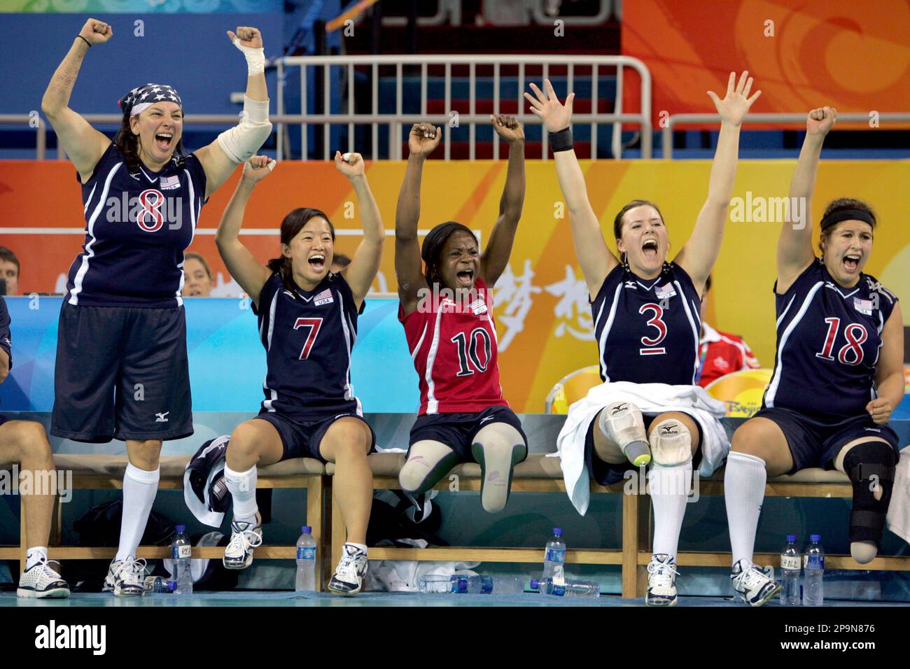 U.S. team player Sugui Kriss, second left, cheers along with her team ...