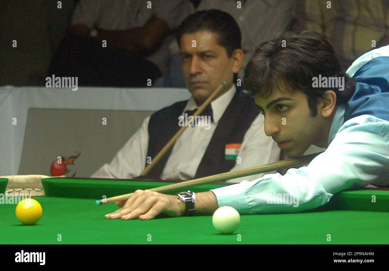 India's Pankaj Advani eyes the ball to play a shot, as Geet Sethi, left ...
