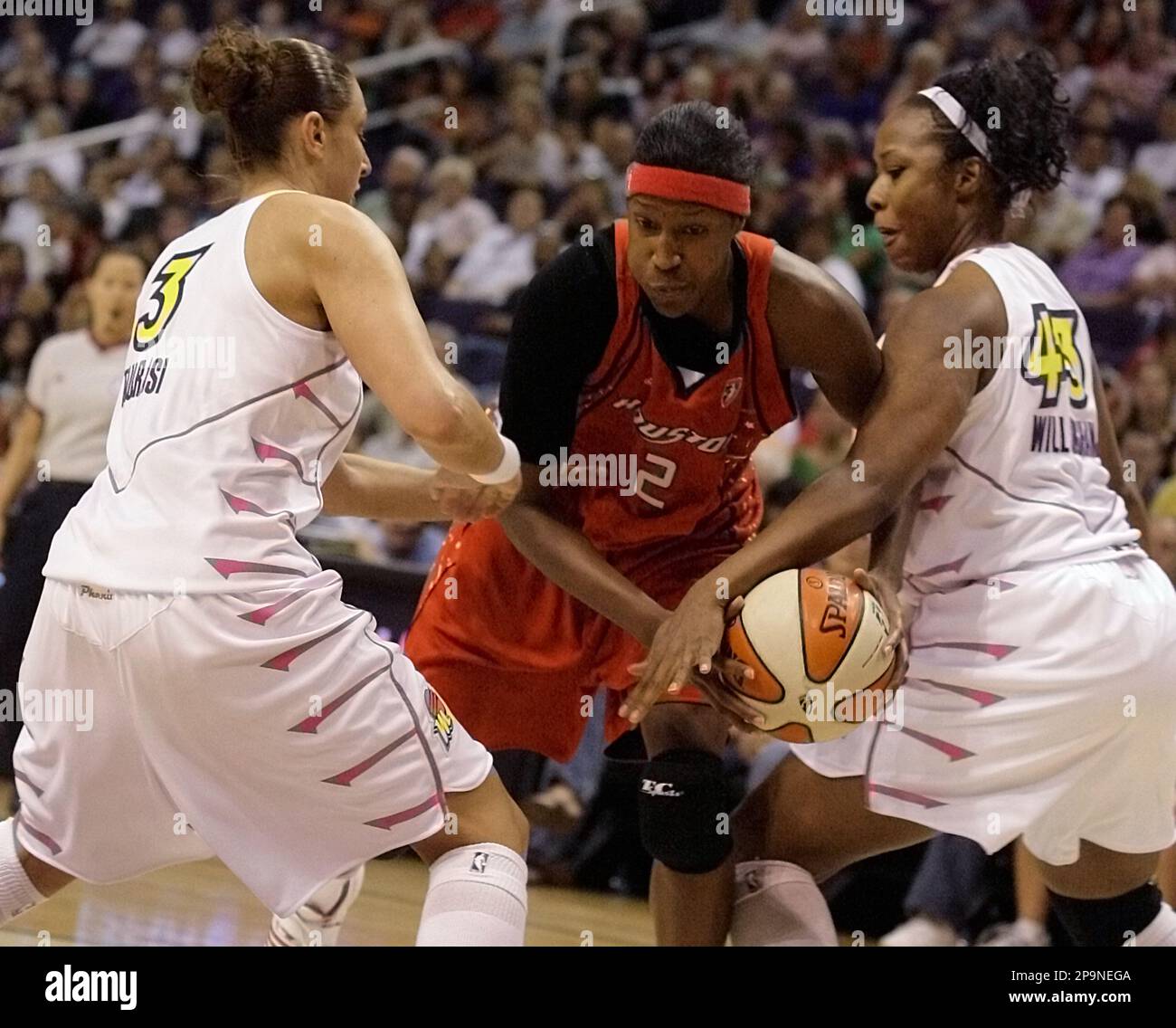 Houston Comets center Michelle Snow, center, is defended by Phoenix ...