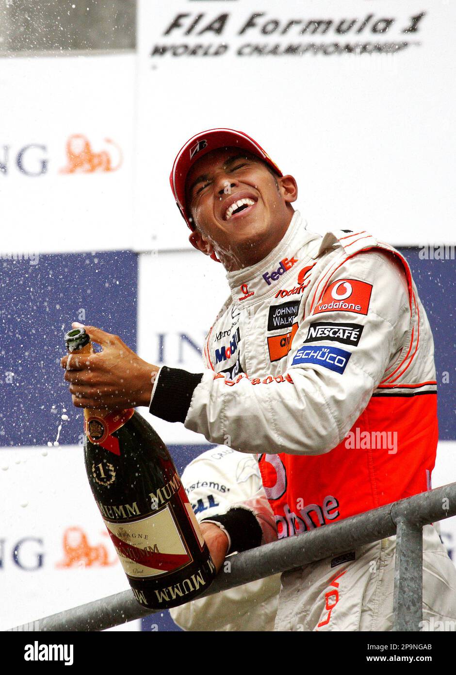 McLaren Mercedes Formula One driver Lewis Hamilton of Britain sprays champagne after he won the ...