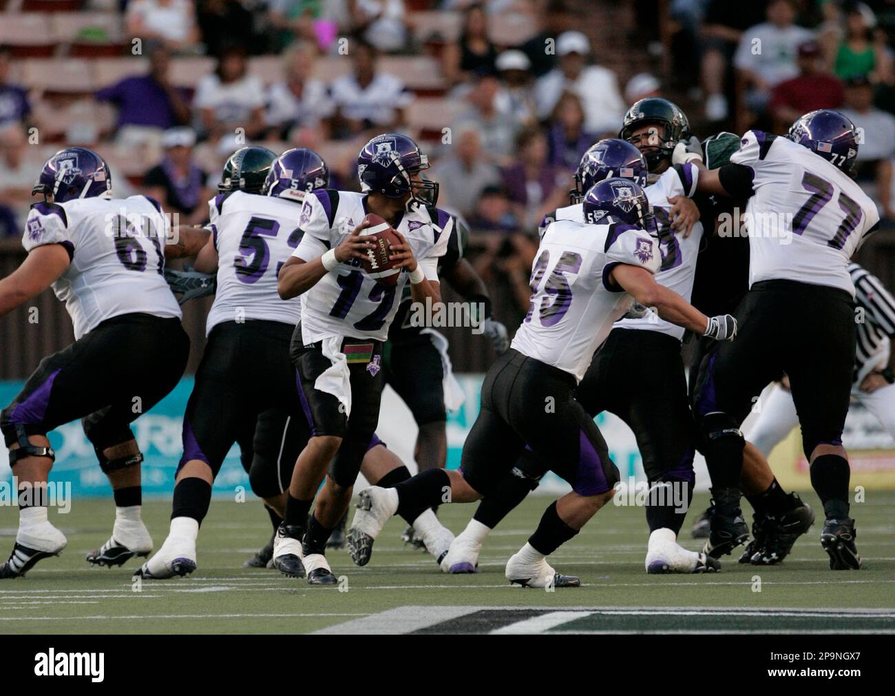 Weber State quarterback Cameron Higgins, center, rolls out to throw the ...