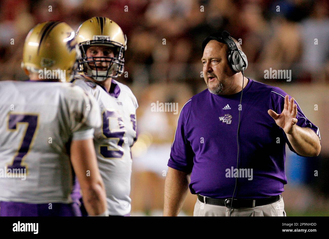 Western Carolina head coach Dennis Wagner, right, talks to his players ...