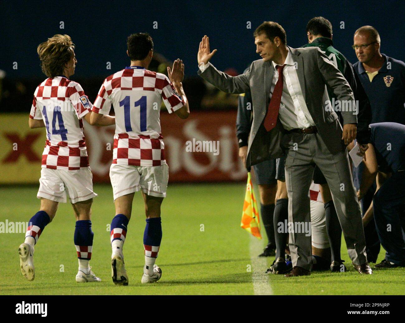 Croatia's coach Slaven Bilic, right, congratulates his players Luka ...