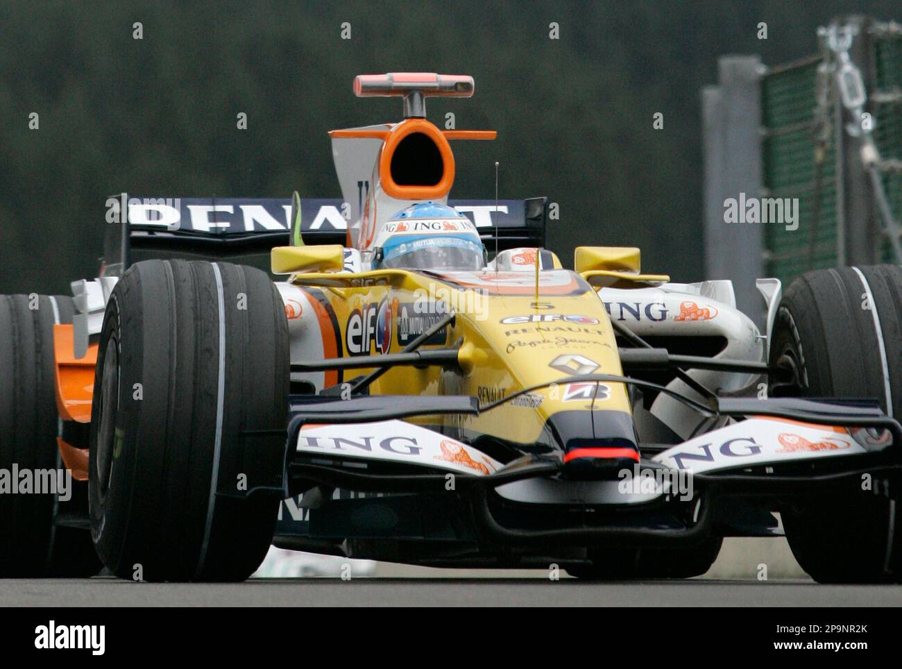 Renault Formula One driver Fernando Alonso of Spain enters the pitlane ...