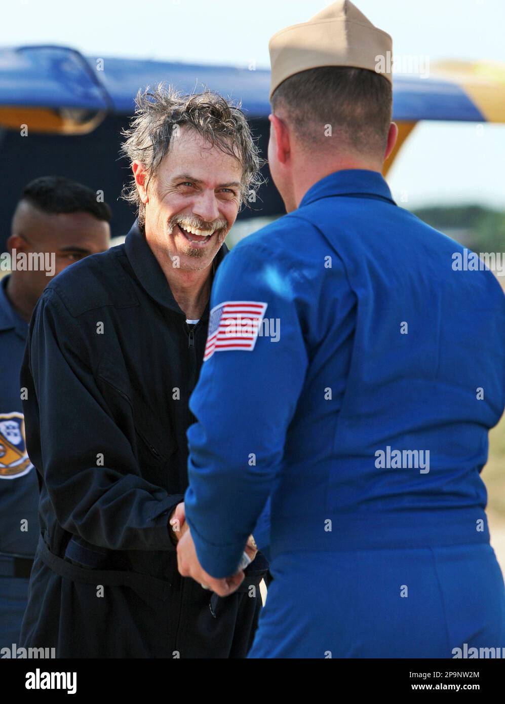 Associated Press writer Glenn Adams, left, is elated and shakes the ...