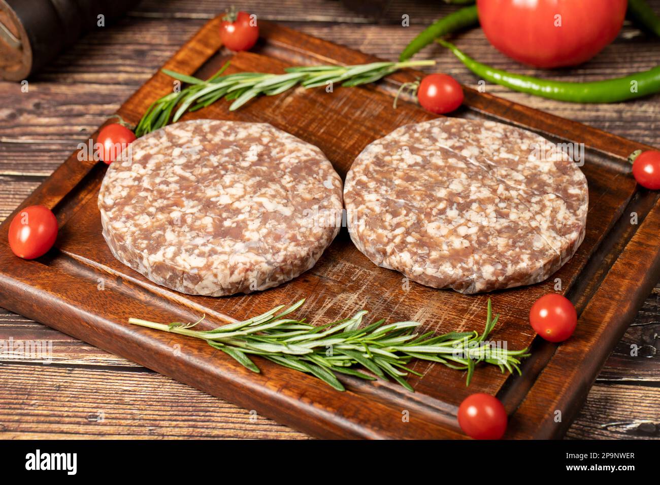 Raw hamburger patties. Beef hamburger patties prepared with spices ...