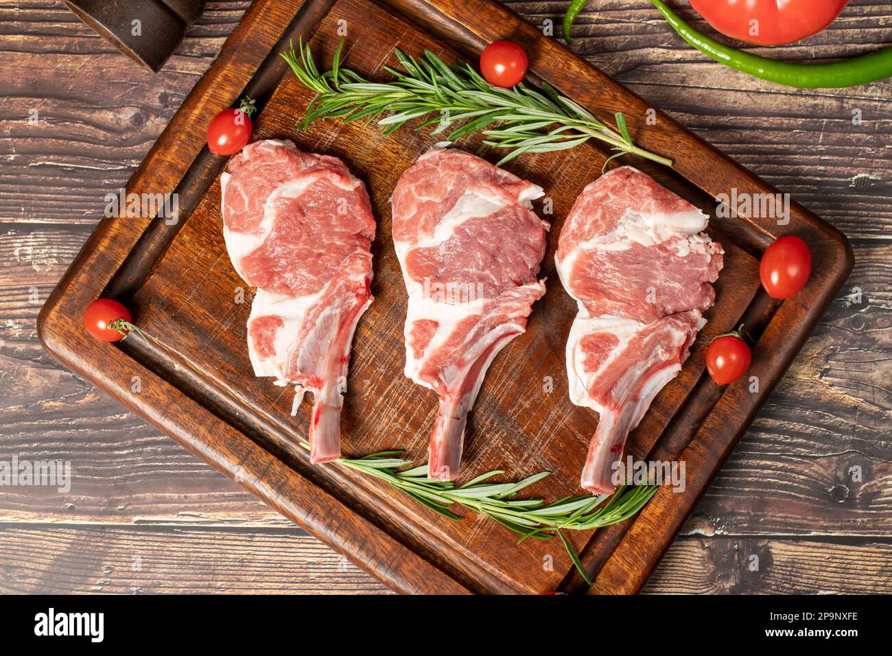 Raw lamb chops. Fresh raw lamb chops with spices and herbs. Wood background. Top view Stock ...