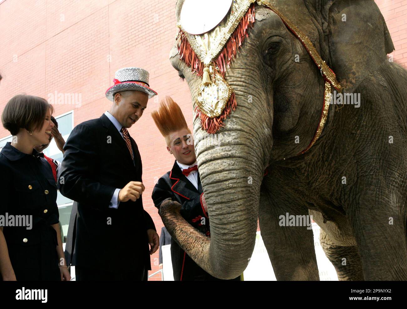 Newark Mayor Cory Booker, second from left, feeds a circus elephant ...