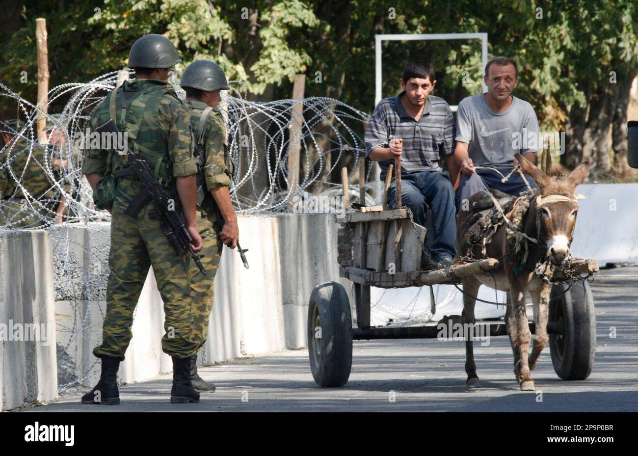 Russian soldiers stand at a Russian checkpoint at Karaleti, 7 km (4 ...