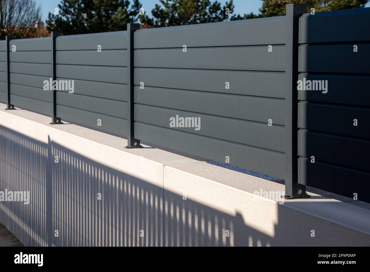 wall grey aluminum barrier and gray fence of private individual house ...