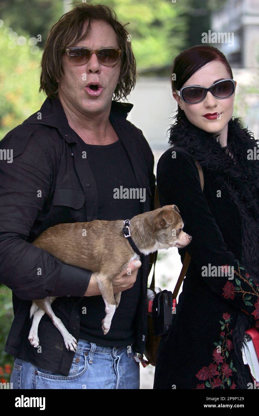 Actor Mickey Rourke, right, with his dog Loki, and actress Evan Rachel ...