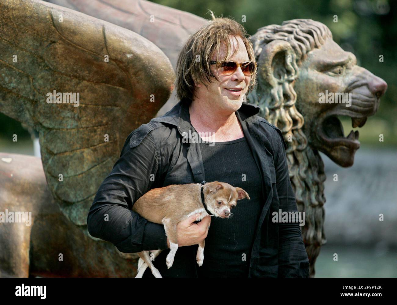 Actor Mickey Rourke, with his dog Loki, arrives to present his movie ...