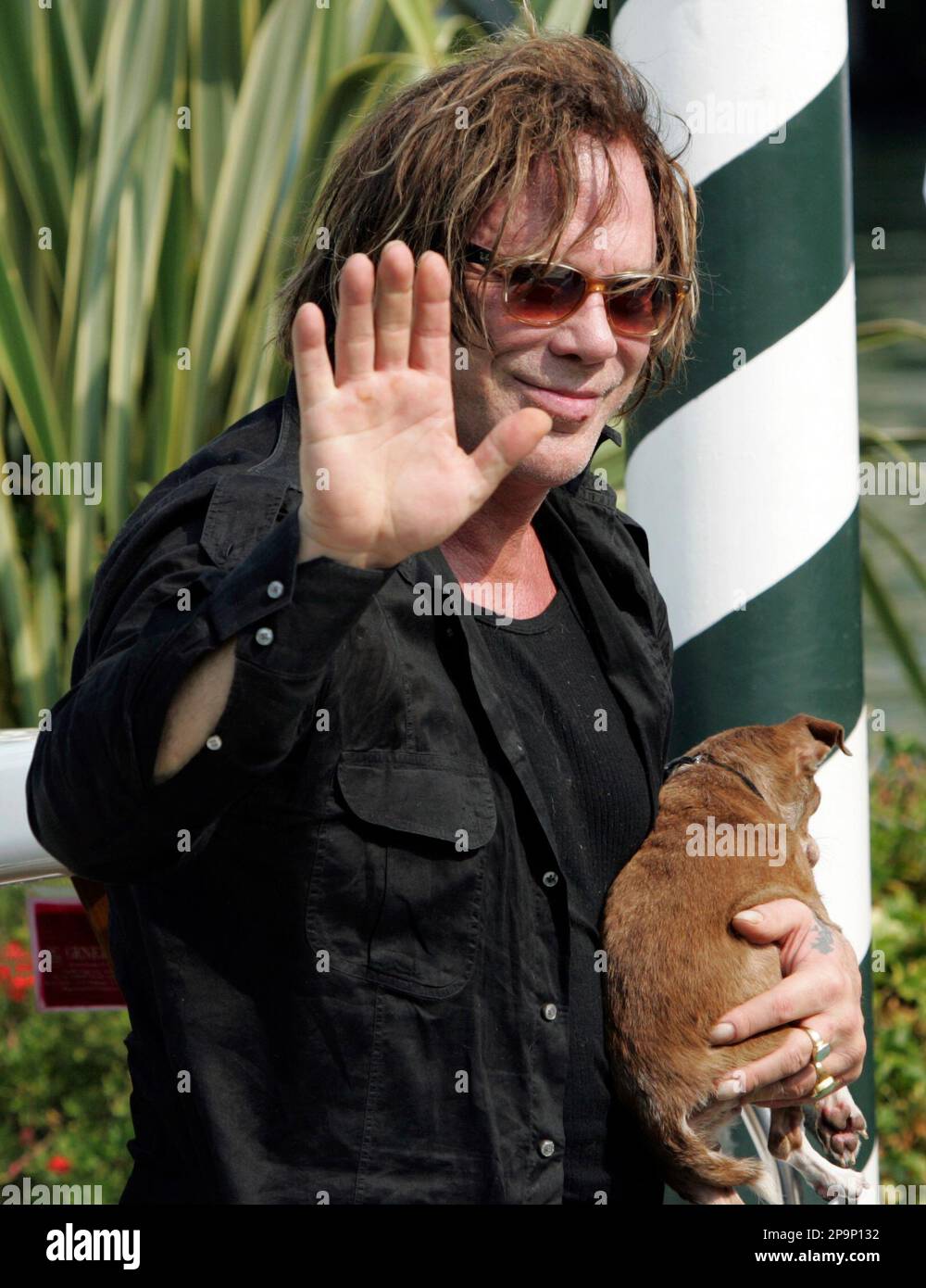 Actor Mickey Rourke, with his dog Loki, arrives to present his movie ...
