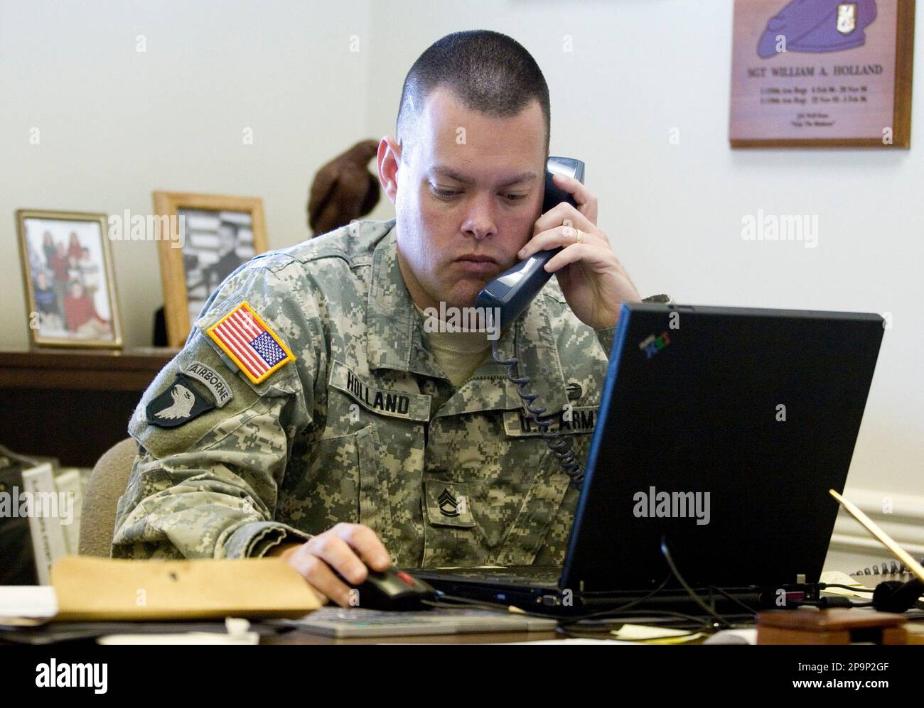 U.S. Army Sgt. First Class Andrew Holland takes a phone call at the ...