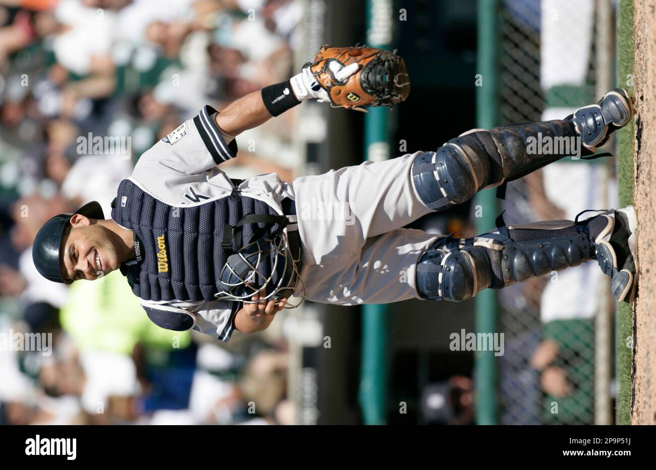 New York Yankees catcher Ivan Rodriguez smiles as he gets behind the ...