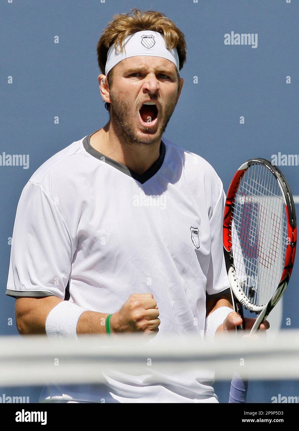 Mardy Fish of the United States celebrates his first set win over Gael ...