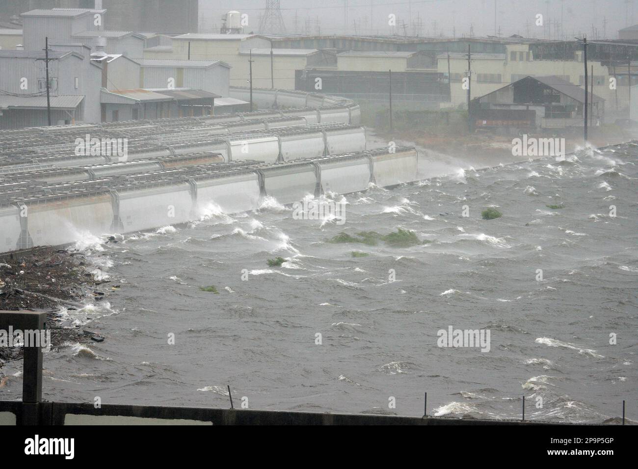 Water is pushed over the flood wall into the upper 9th Ward from the ...