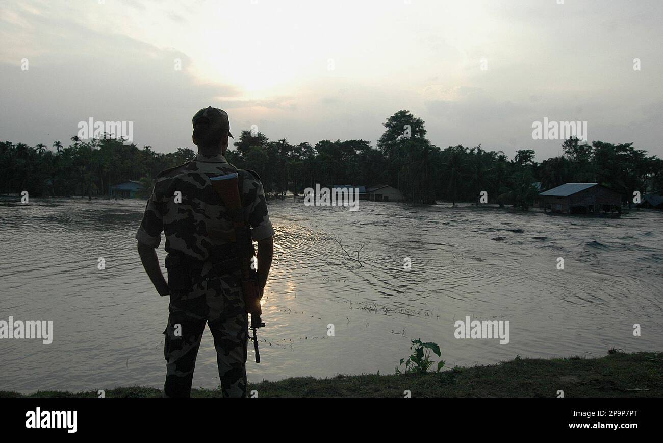 An Indian para military soldier looks at the submerged Puthimari ...