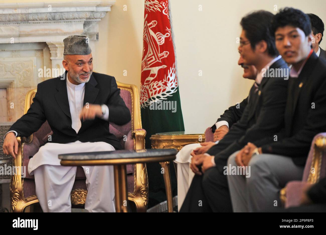 Afghan President Hamid Karzai , left, talks to the Afghan Olympic ...
