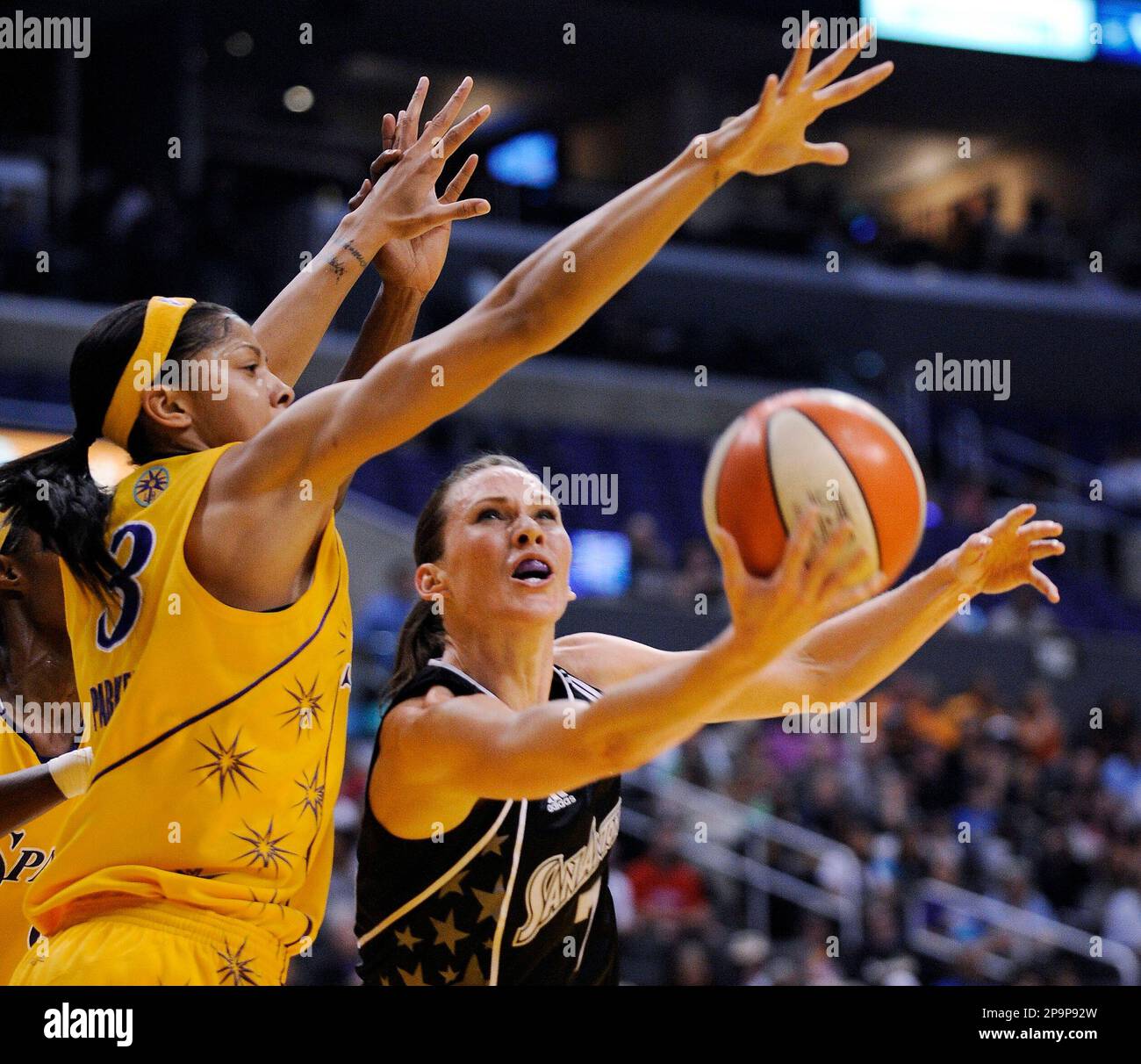 San Antonio Silver Stars' Erin Buescher, right, goes up for a layup ...