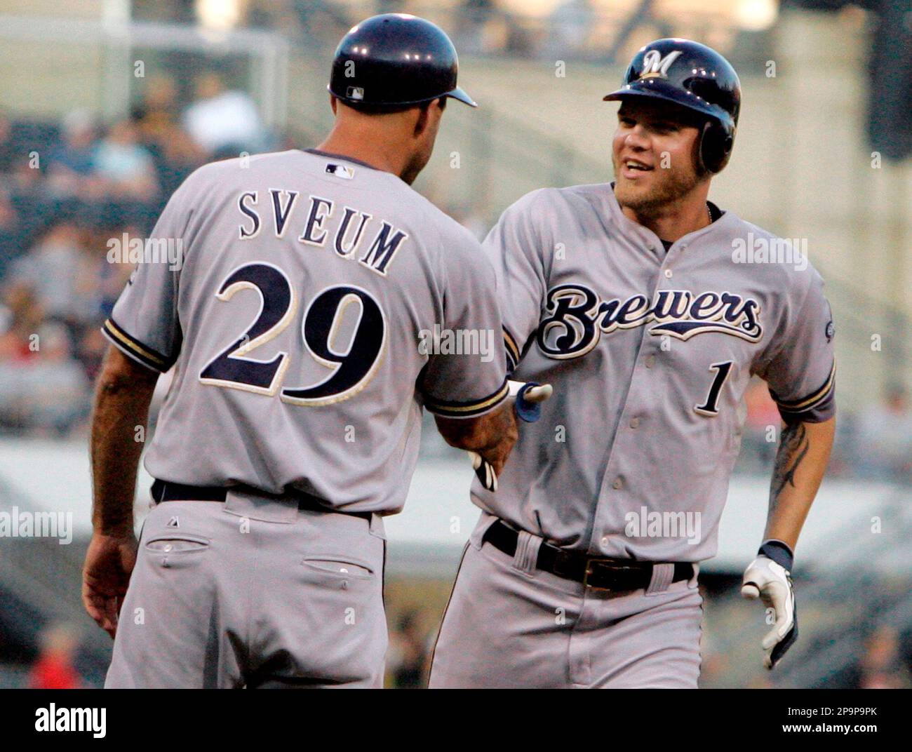Milwaukee Brewers' Corey Hart (1) rounds third to greetings from coach ...