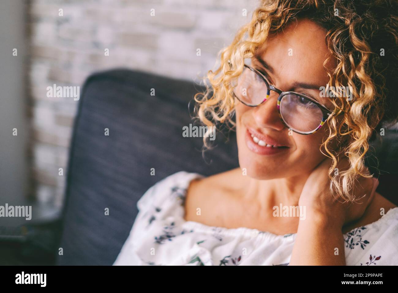 Happy woman smile and massage her neck alone at home. Inner balance and ...