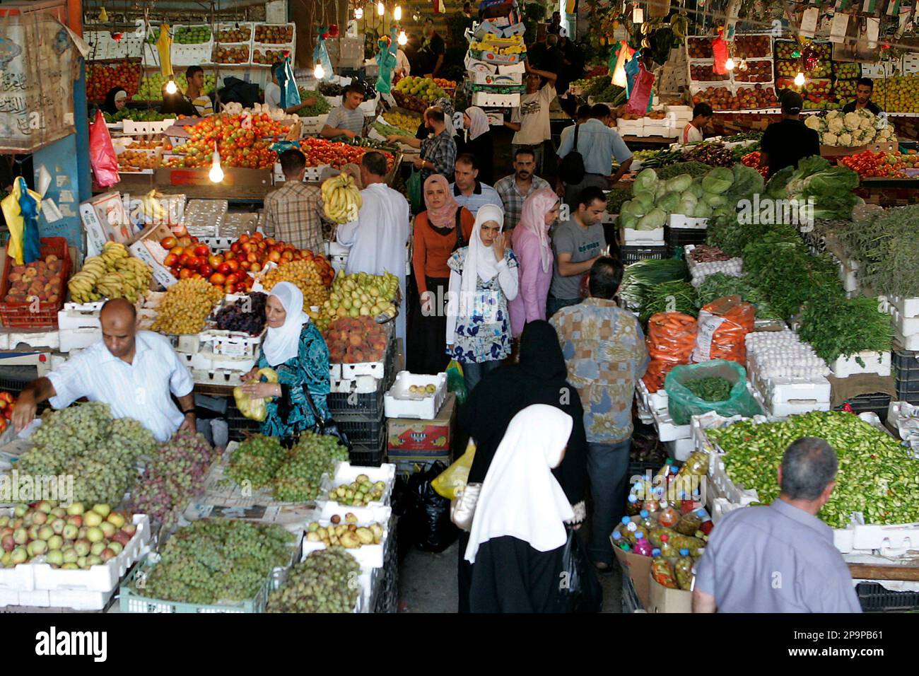 Jordanians shops in a market in Amman, Jordan, Saturday, Aug. 30, 2008 ...