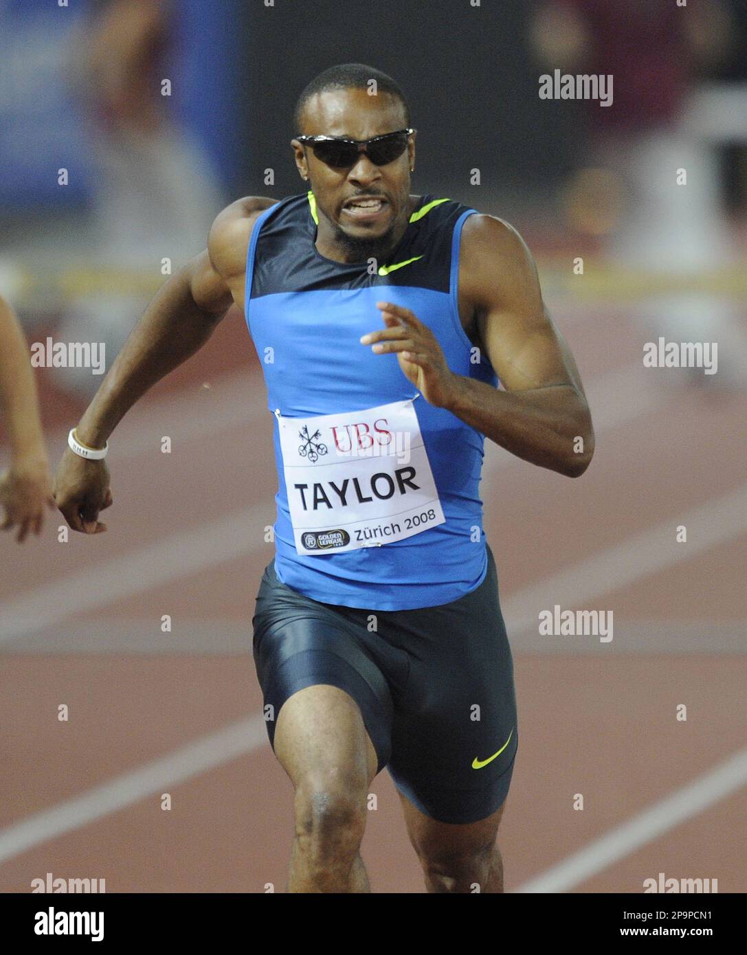 Angelo Taylor from the U.S. speeds to win the 400 meters hurdles ...