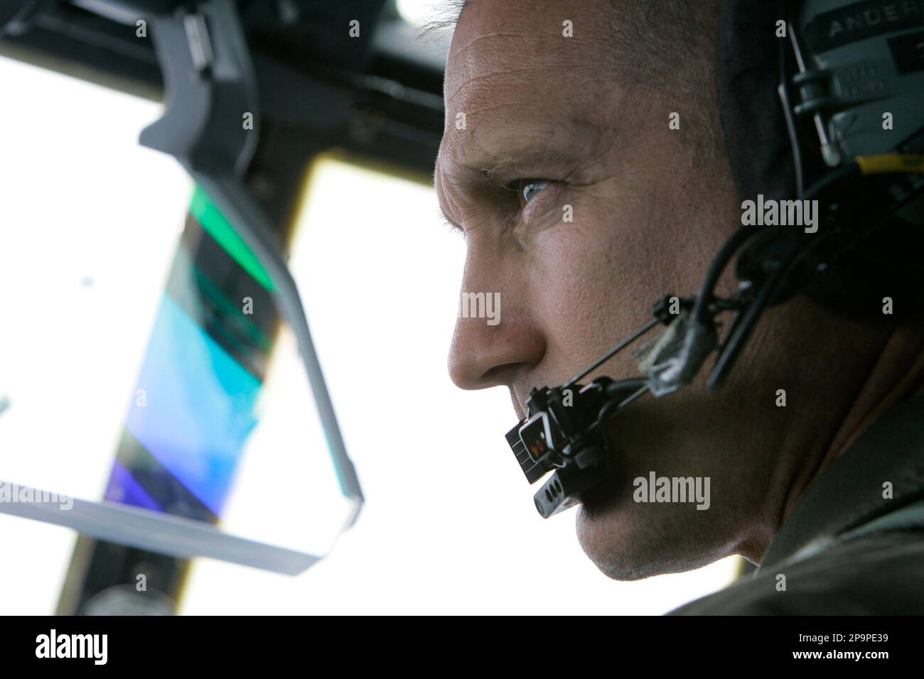 Aircraft Commander, Lt. Col. Troy "Bear" Anderson looks out the window ...