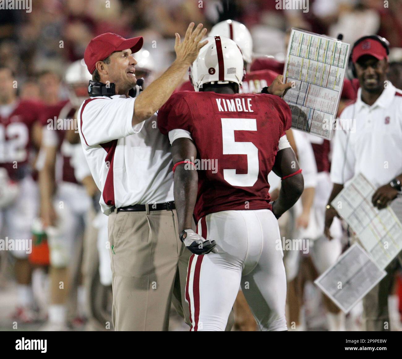 Stanford head coach Jim Harbaugh, left, congratulates running back ...