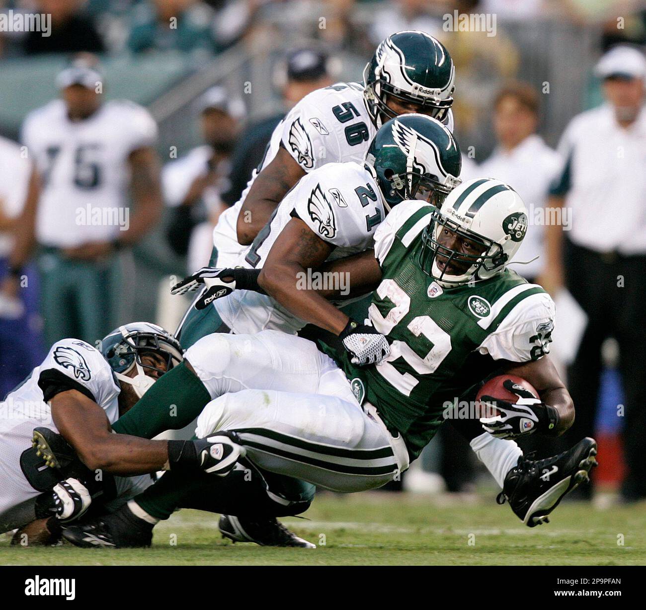 New York Jets running back Jessie Chatman (22) is brought down by ...