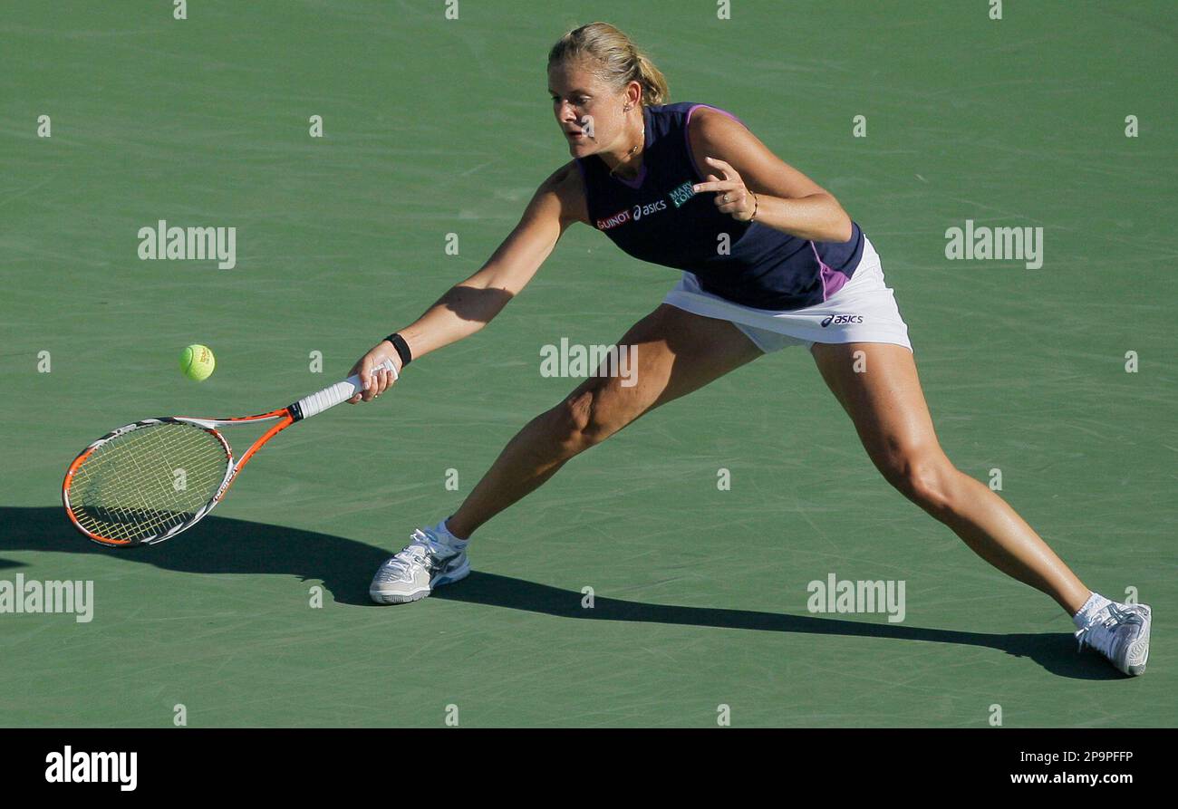 Julie Coin, of France, reaches for a shot from Ana Ivanovic, of Serbia ...