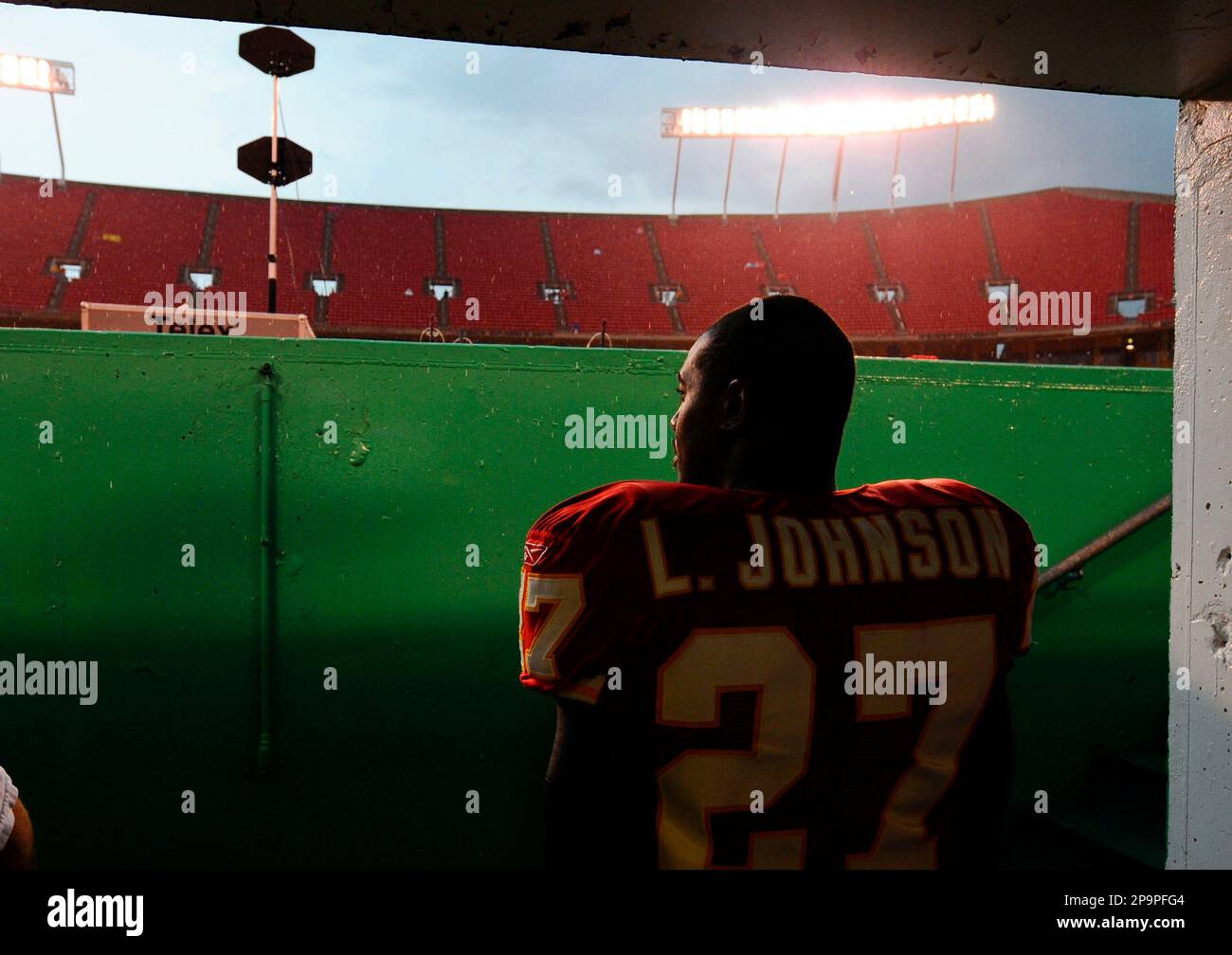 Kansas City Chiefs running back Larry Johnson watches the rain fall as ...