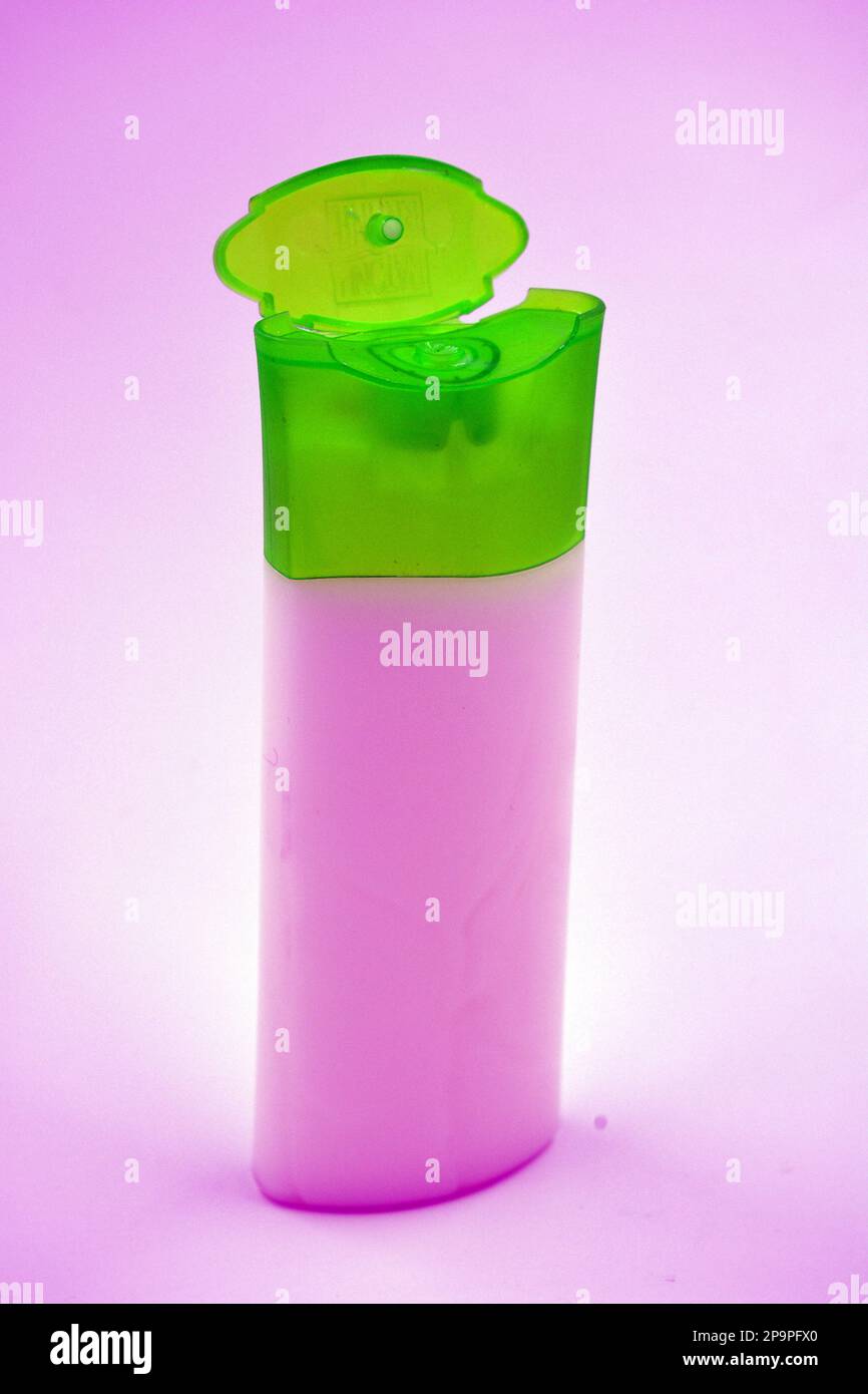 Cosmetic pink facial, body care product in a plastic bottle with green ...