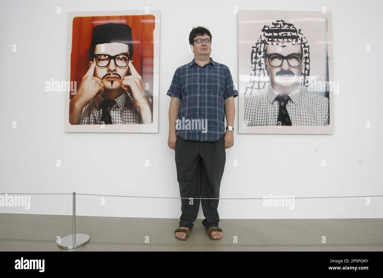 British artist Mark Wallinger poses next to his work "Passport Control ...