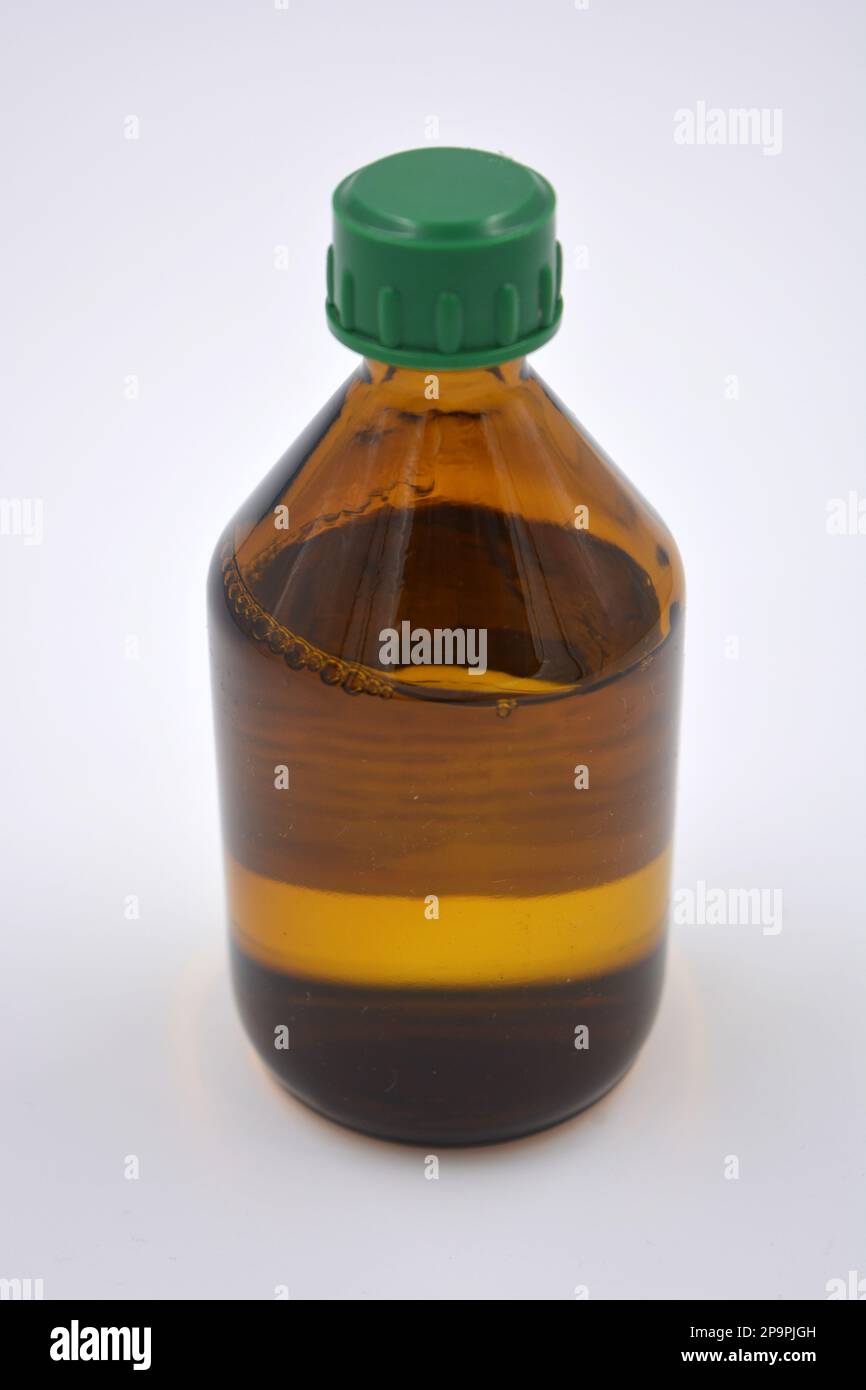 A medical small bottle of medicine with a liquid made of black, brown ...