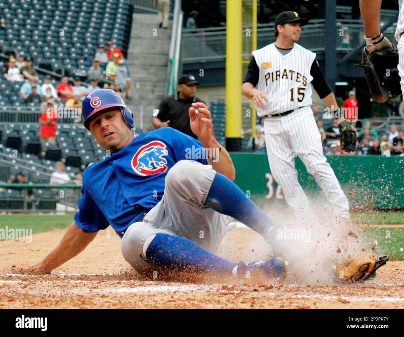 Chicago Cubs' Reed Johnson, left, scores on a ground out to Pittsburgh ...