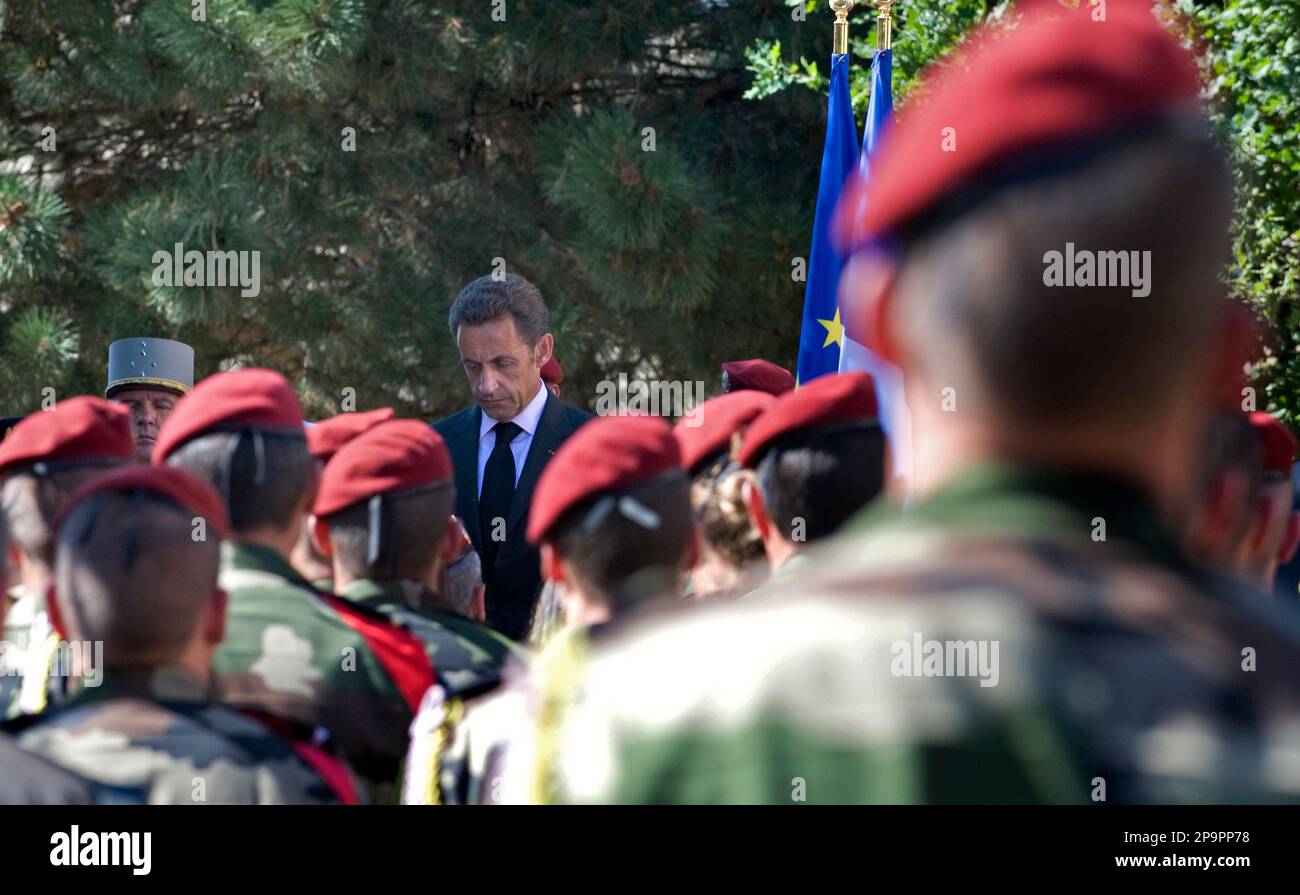 French President Nicolas Sarkozy, centre background, observes a minute ...
