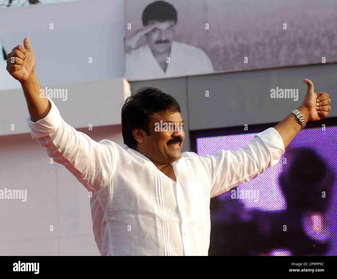 Telugu film actor Chiranjeevi reacts to supporters at a public rally ...