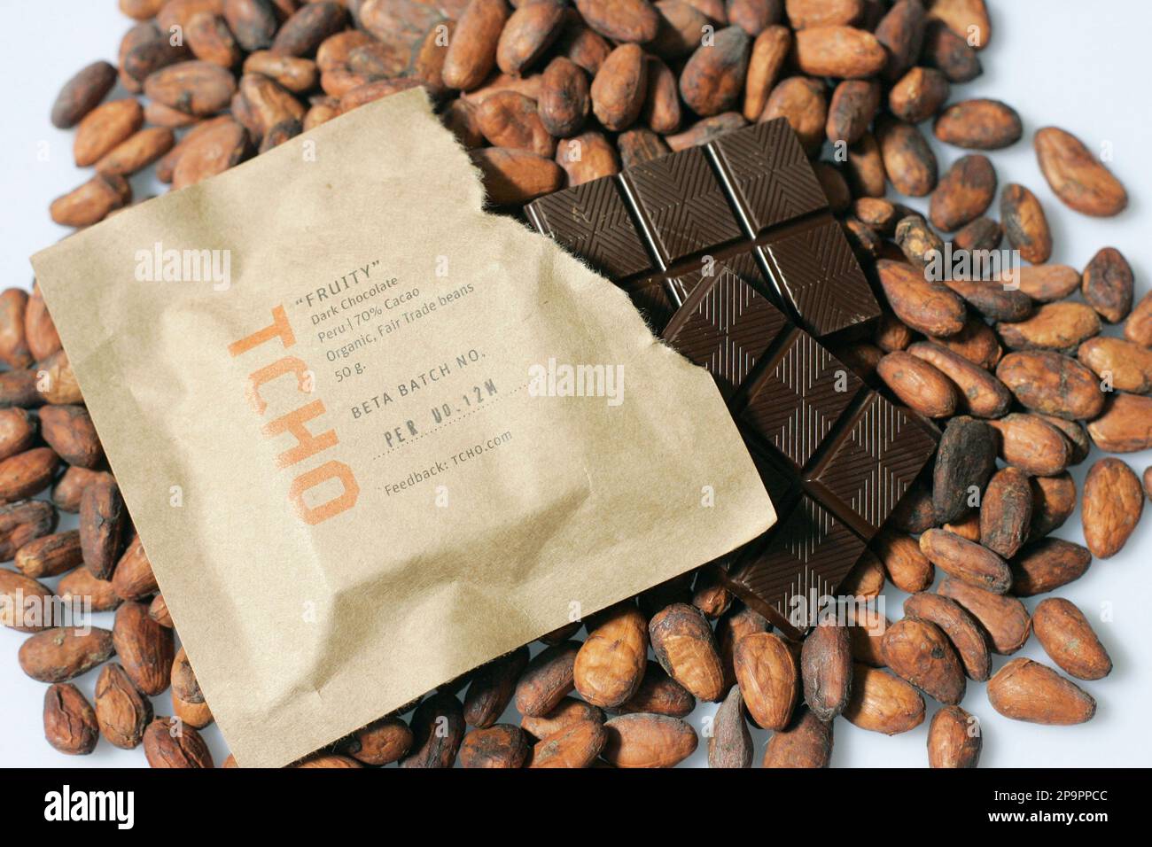 A prototype package and finished dark chocolate is shown atop cacao ...