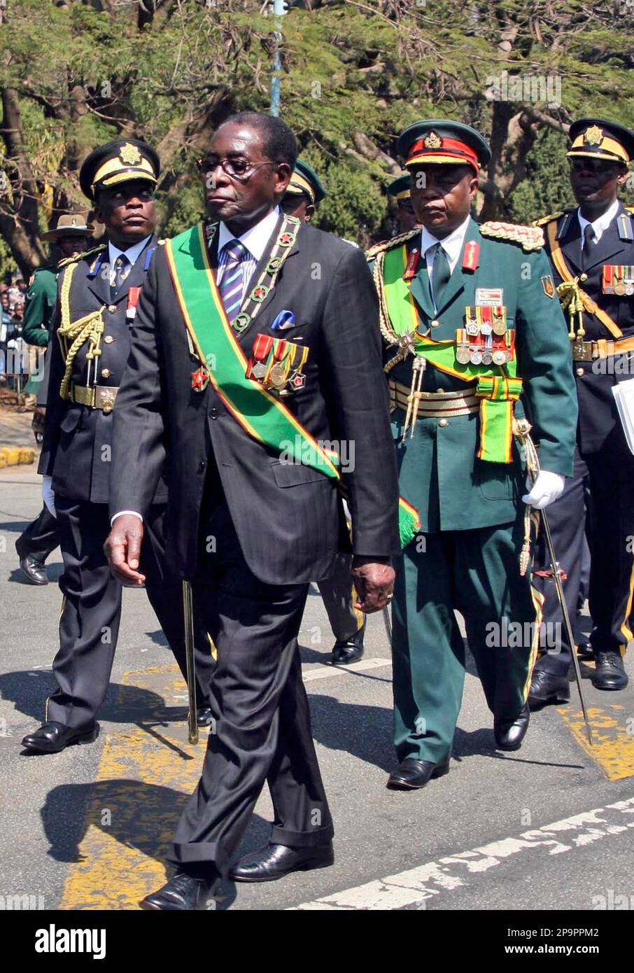 Zimbabwe's President Robert Mugabe, second from left, inspects the ...