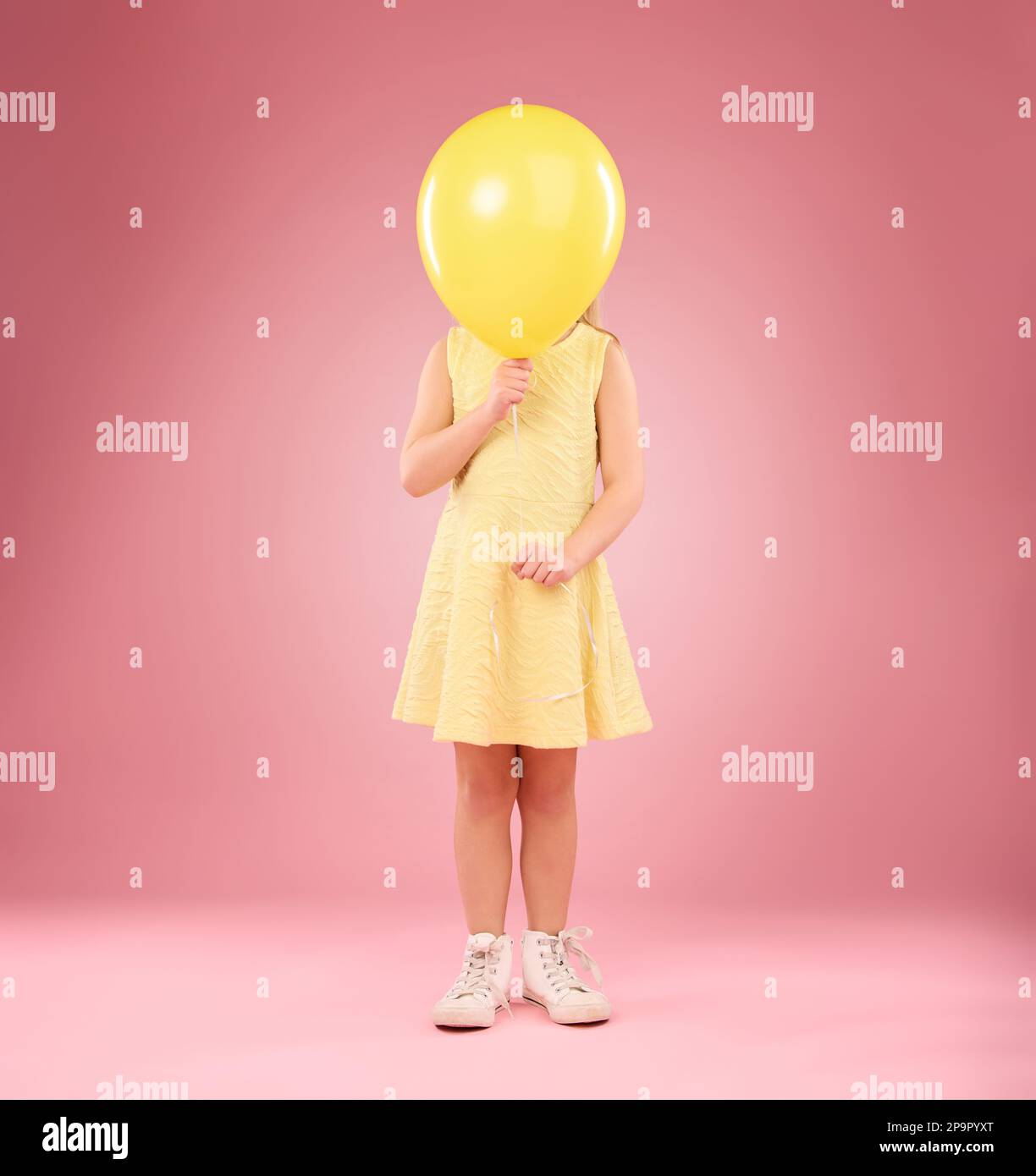 Balloon cover face, girl and child in studio isolated on a pink ...