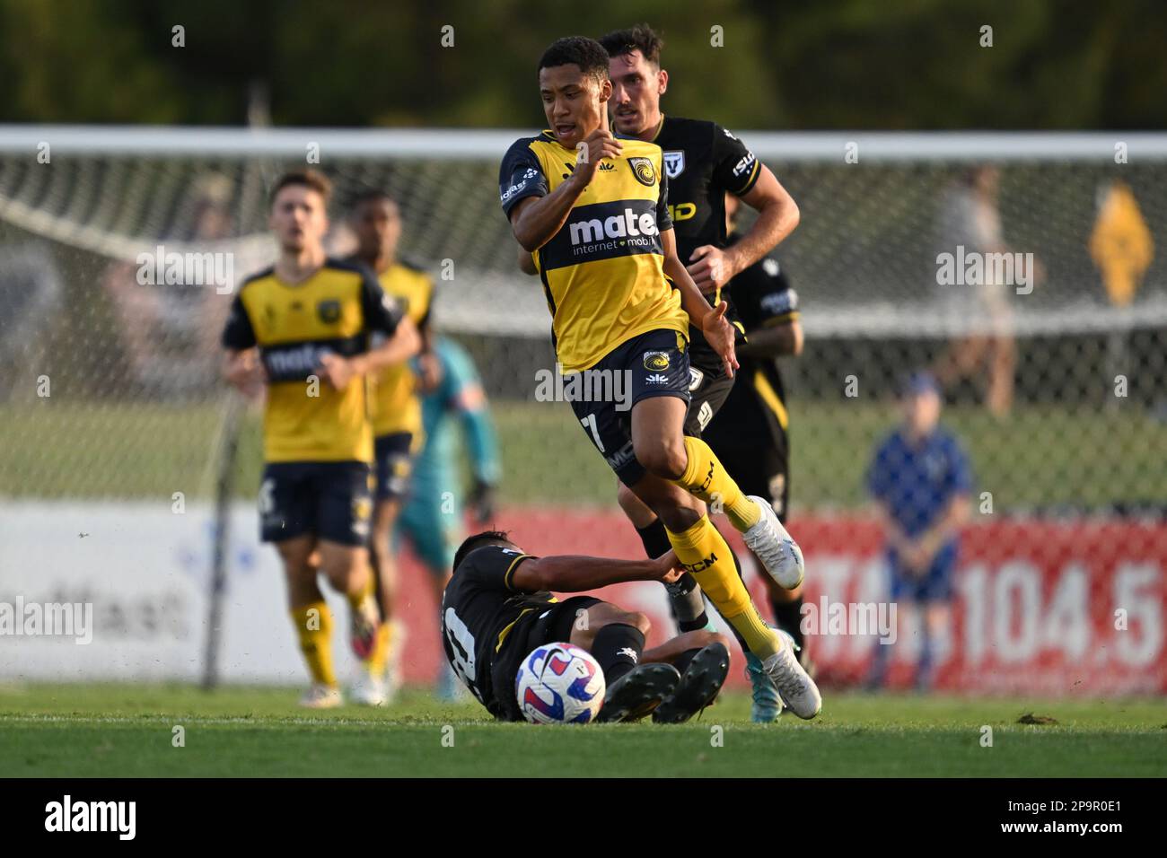 Jason Romero of Macarthur slides in to tackle Samuel Silvera of the ...