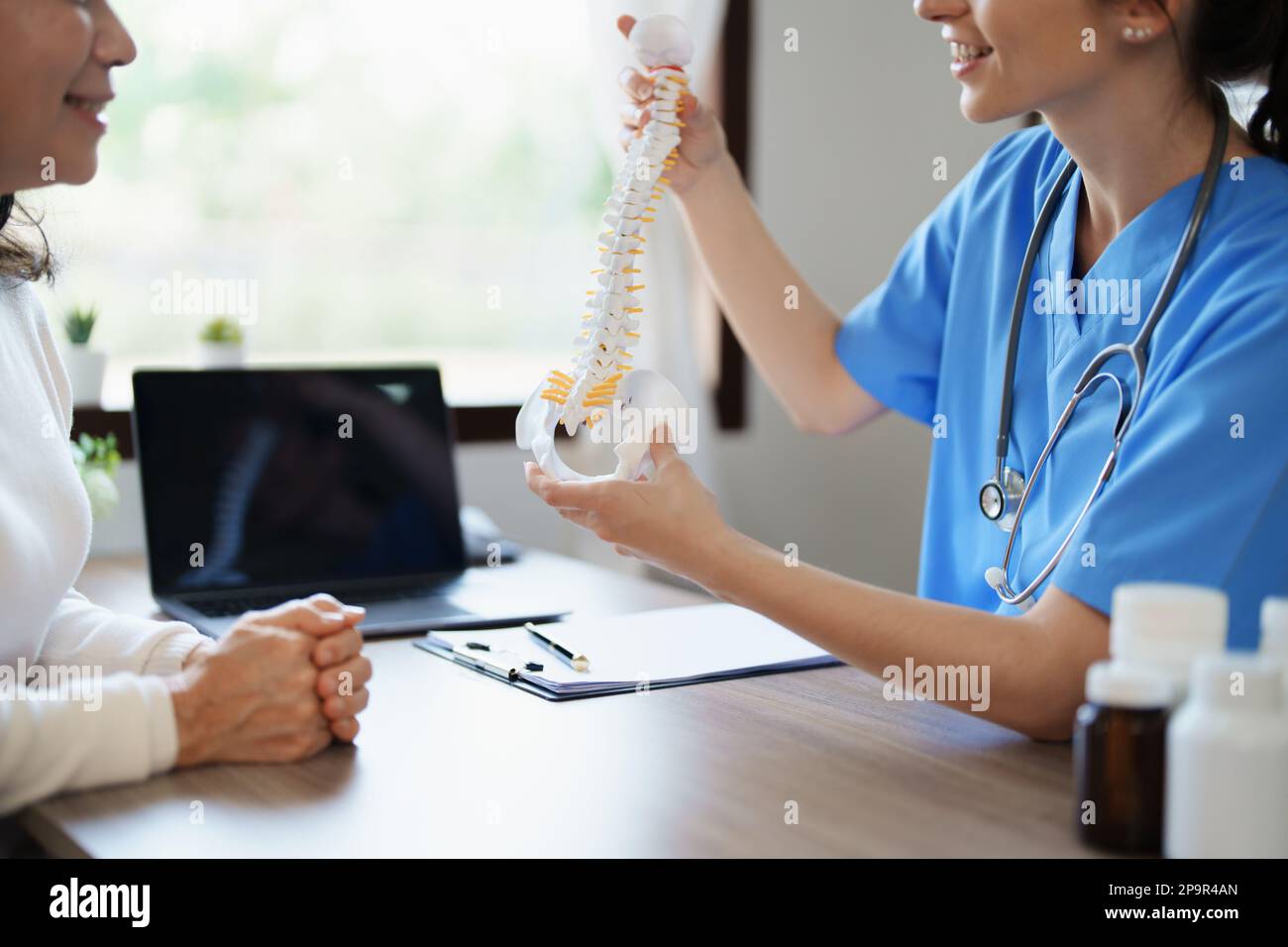 Portrait of a female doctor talking to an elderly patient about ...