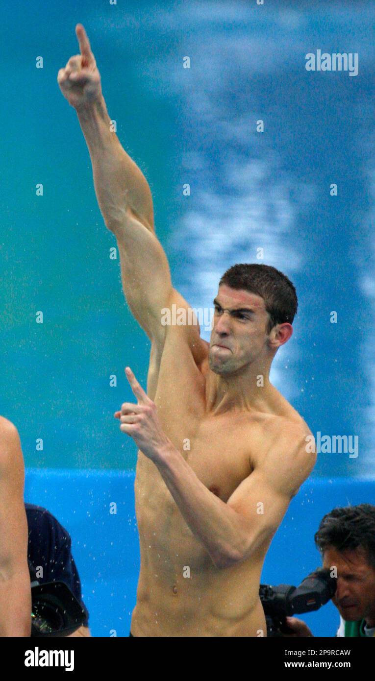 Michael Phelps of the United States celebrates after winning the gold ...