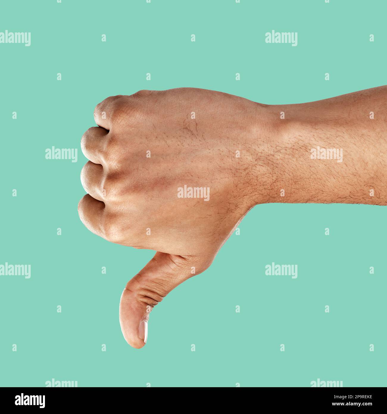 Hand, thumbs down and negative emoji with a man in the studio on a ...
